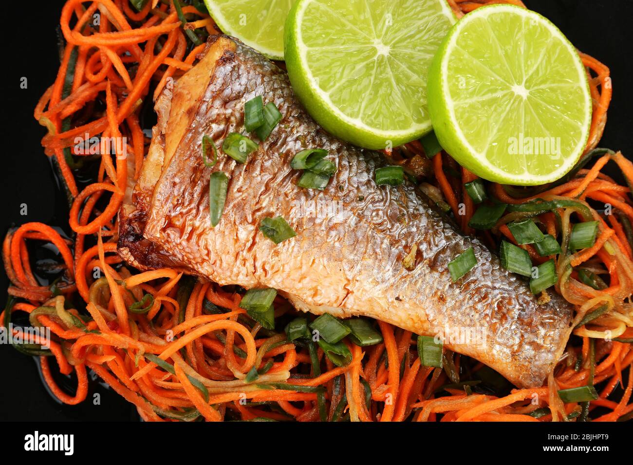 Plate with delicious fish and garnish, closeup Stock Photo - Alamy