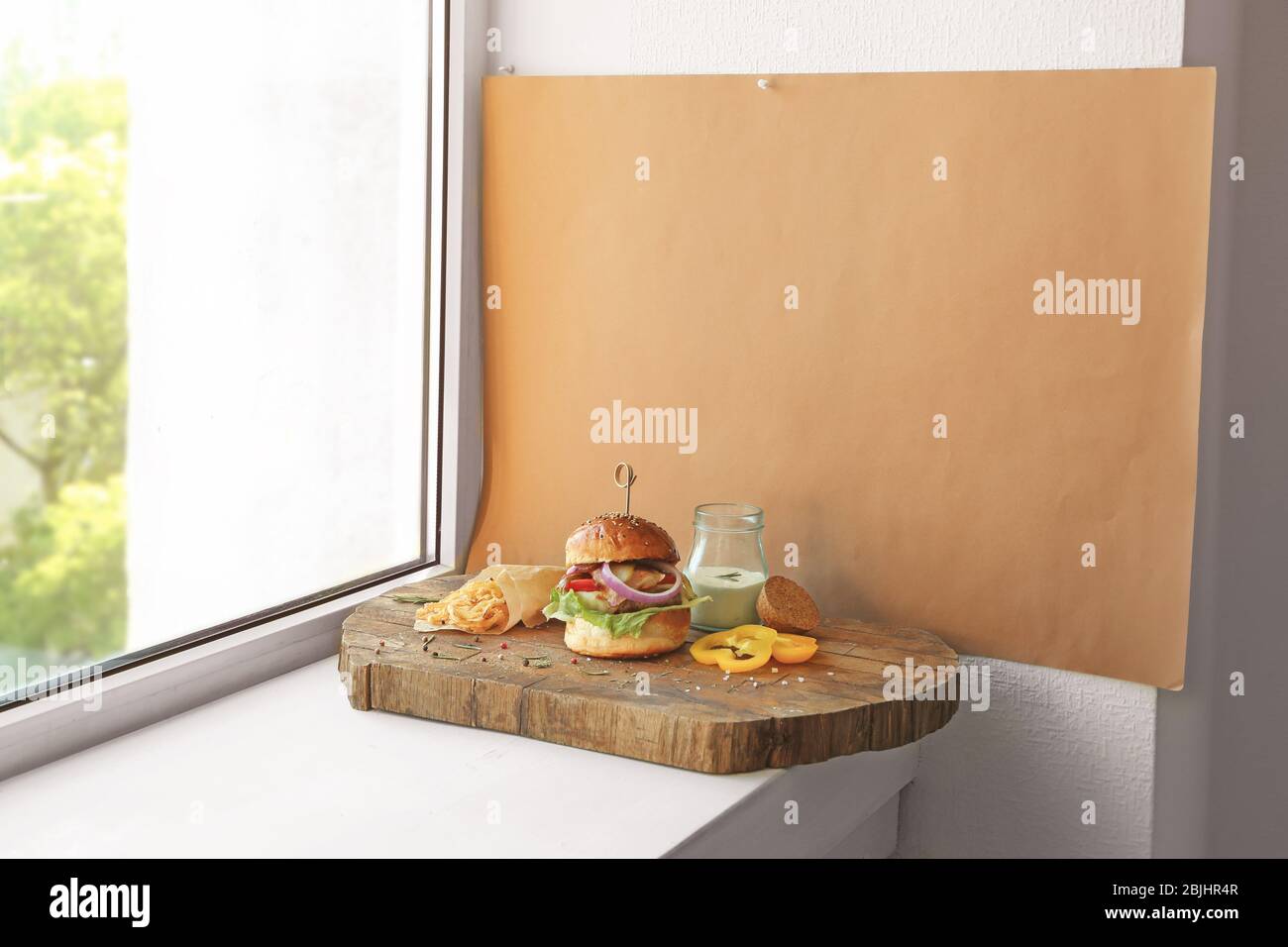 Composition with tasty homemade burger on window sill Stock Photo - Alamy