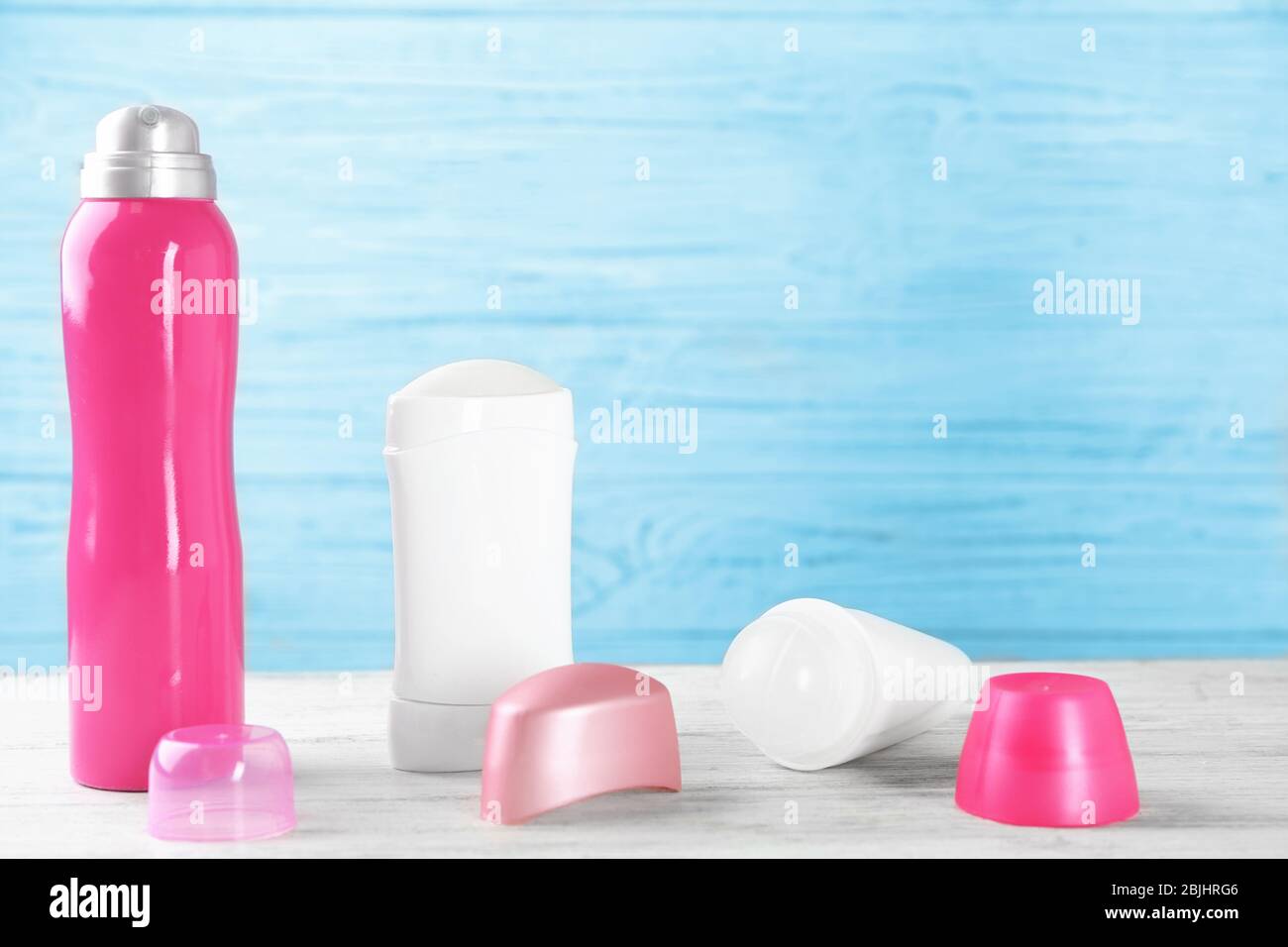 Different deodorants on wooden background Stock Photo - Alamy