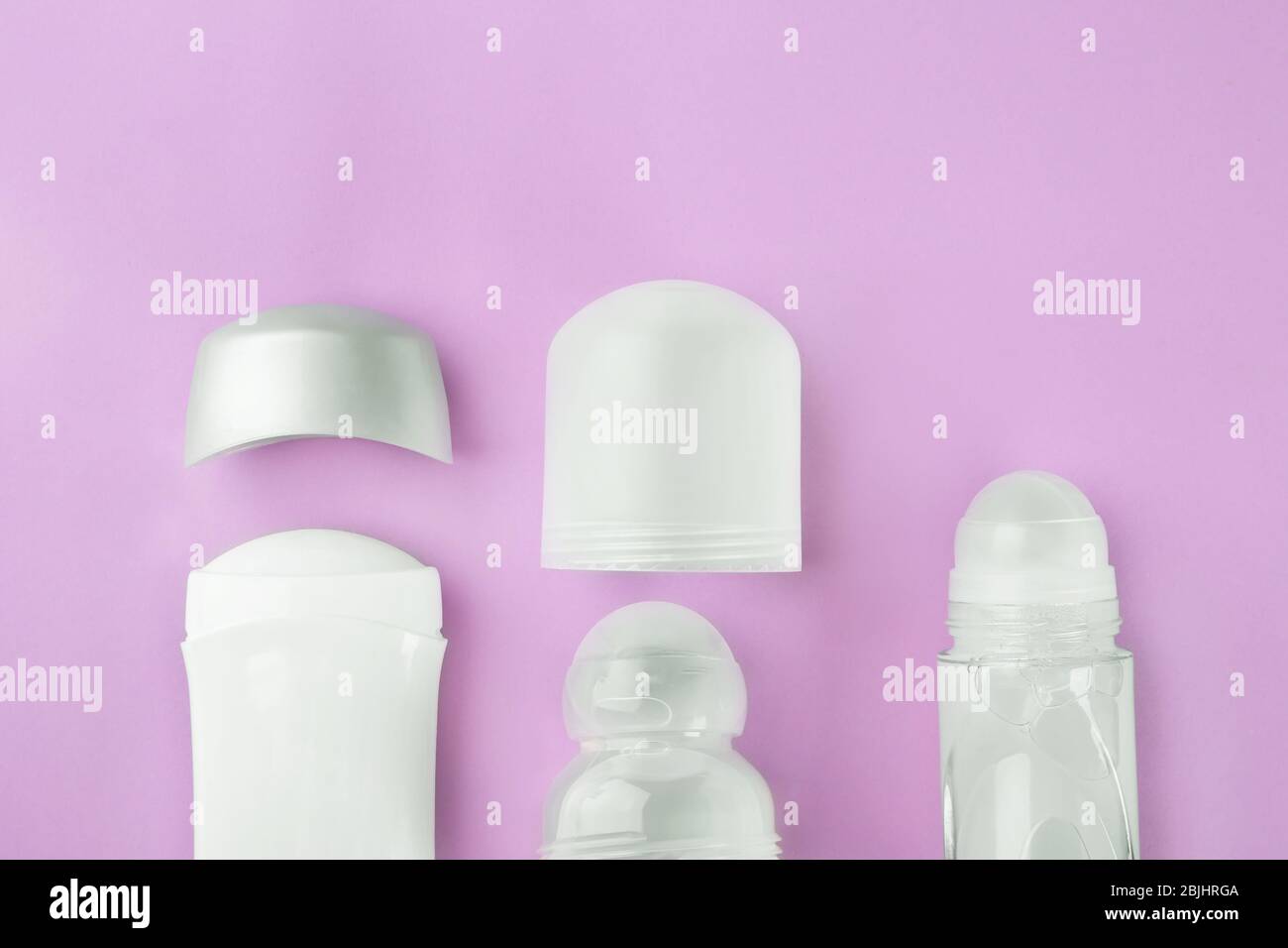 Different deodorants on color background Stock Photo - Alamy