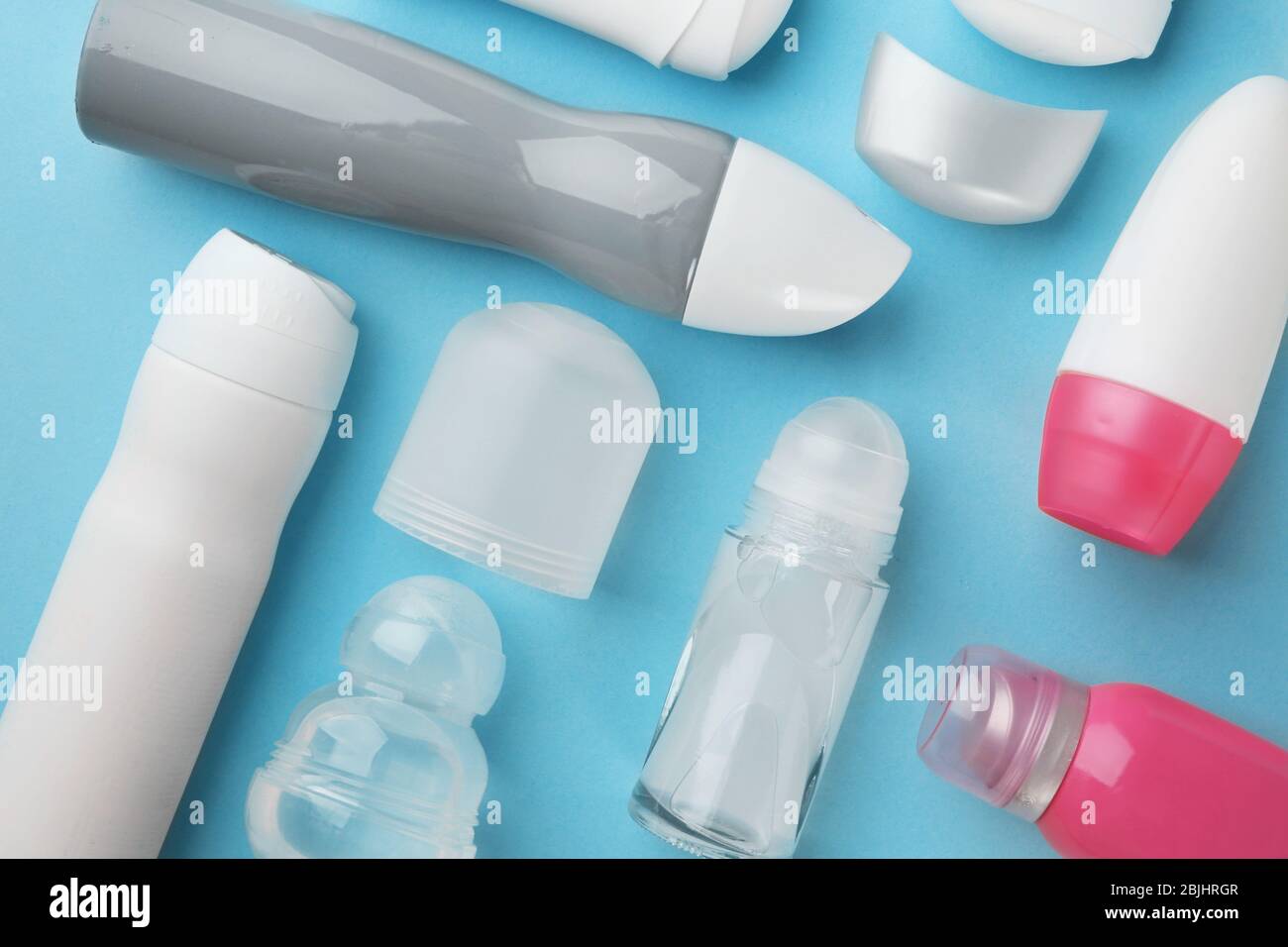 Different deodorants on color background Stock Photo - Alamy