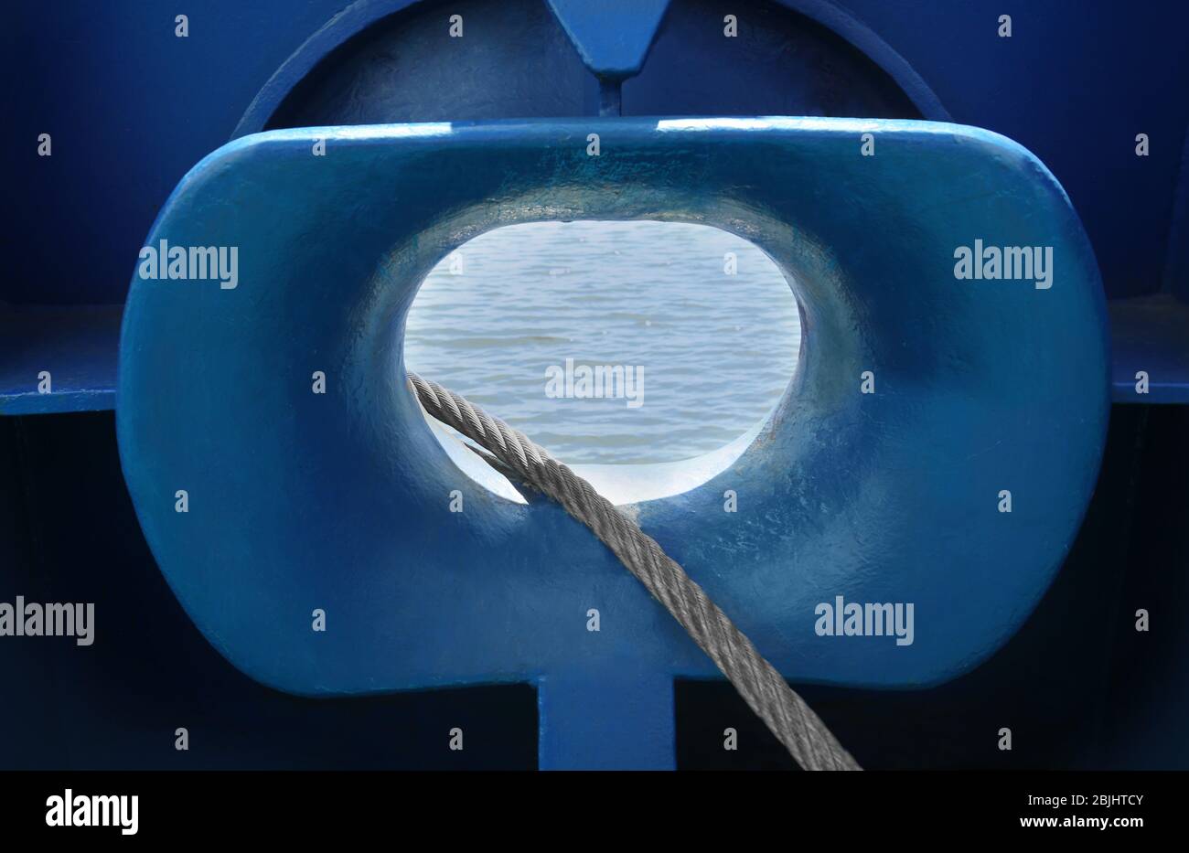 Hole in ship hull and hawser for berthing Stock Photo - Alamy