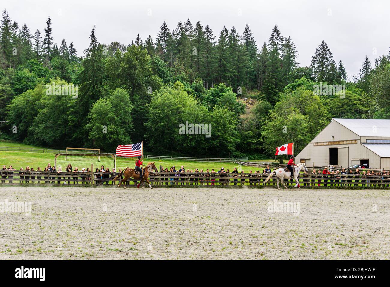 MAPLE RIDGE, CANADA - JULY 5, 2019: horse riders with flags on the ...