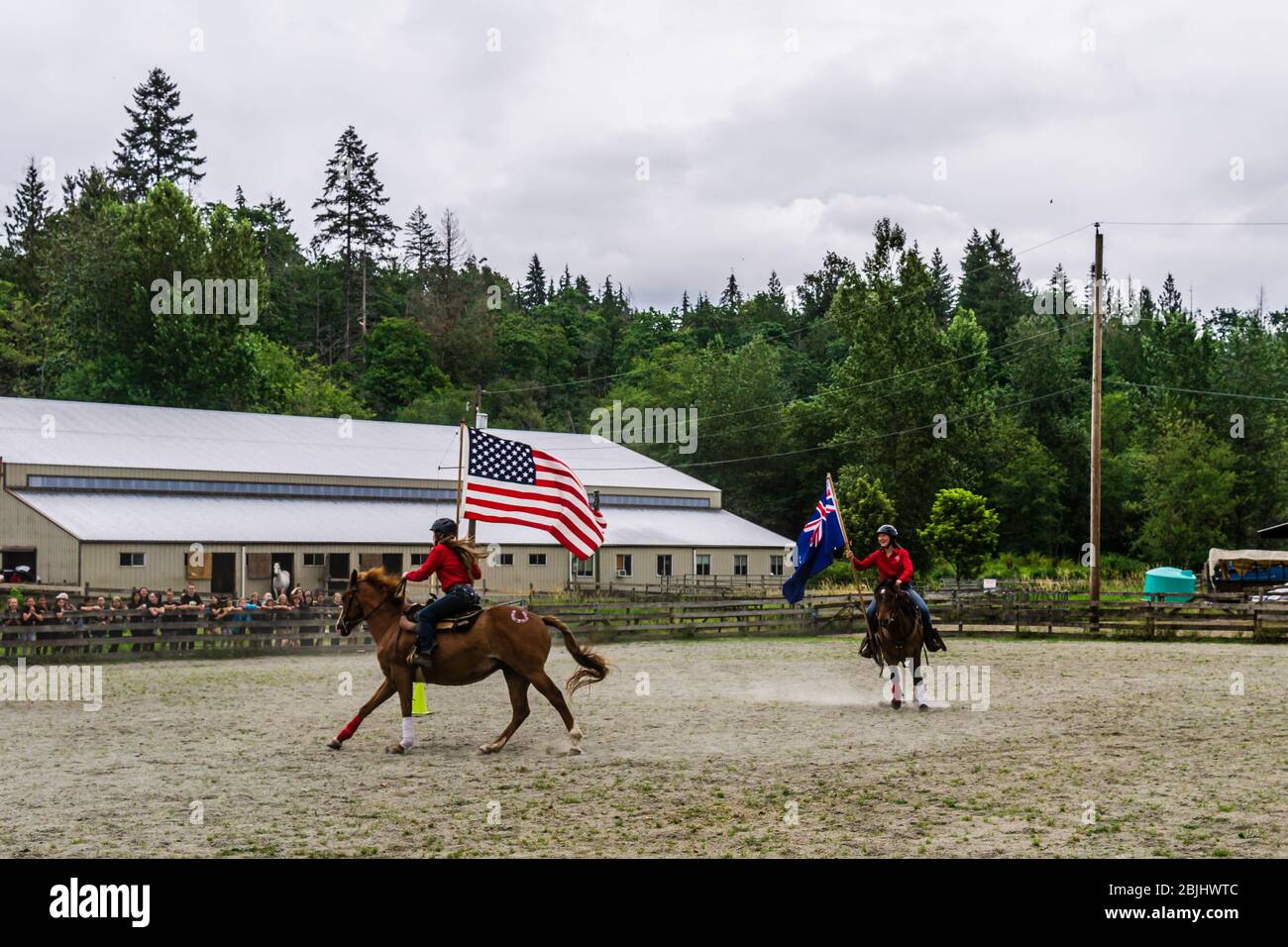 MAPLE RIDGE, CANADA - JULY 5, 2019: horse riders with flags on the ...