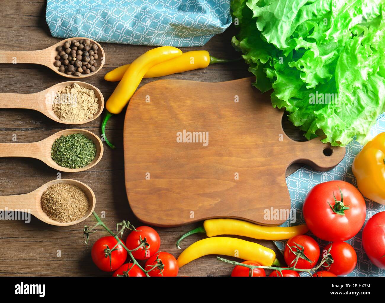Wooden board with vegetables on kitchen table. Cooking classes concept ...
