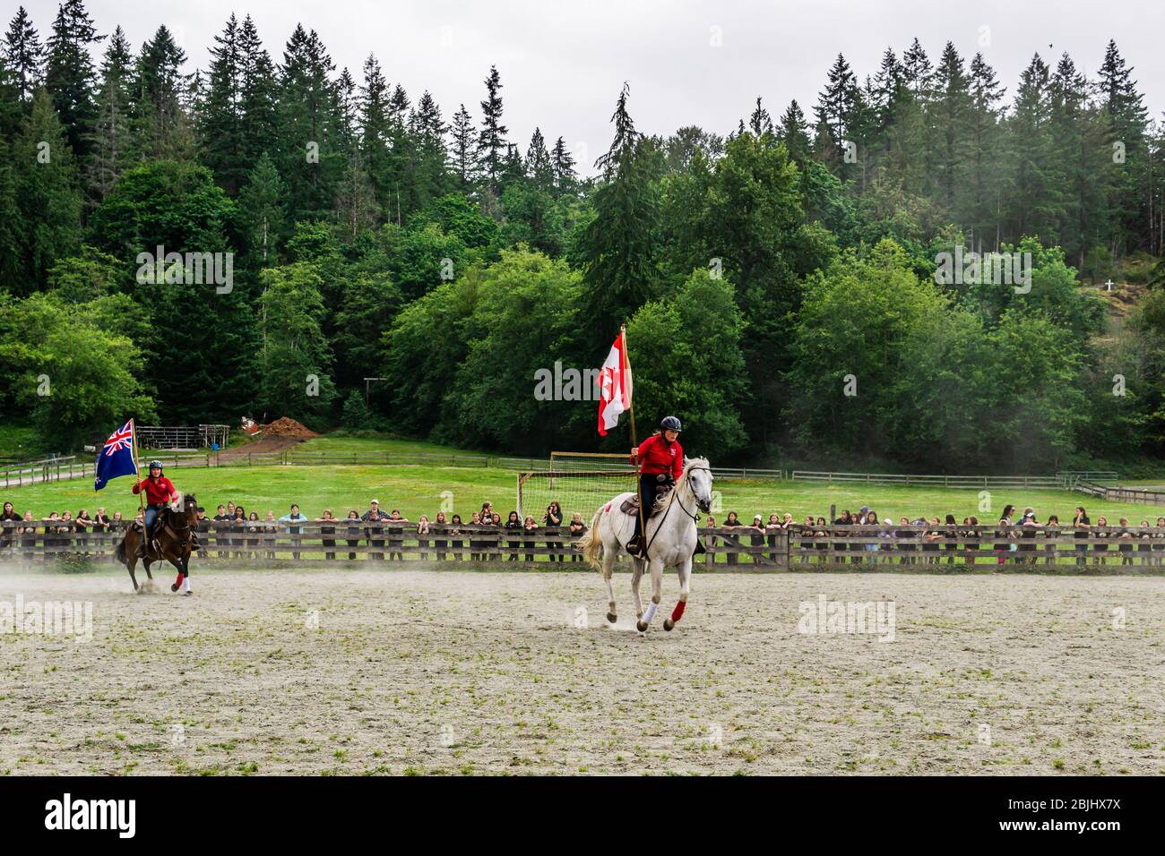MAPLE RIDGE, CANADA - JULY 5, 2019: horse riders with flags on the ...