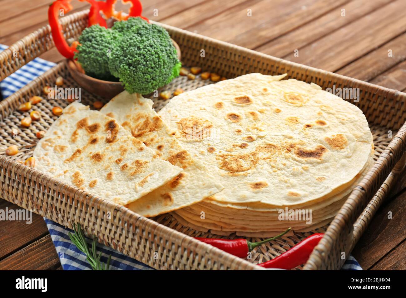 Wicker tray with delicious tortillas on kitchen table Stock Photo - Alamy