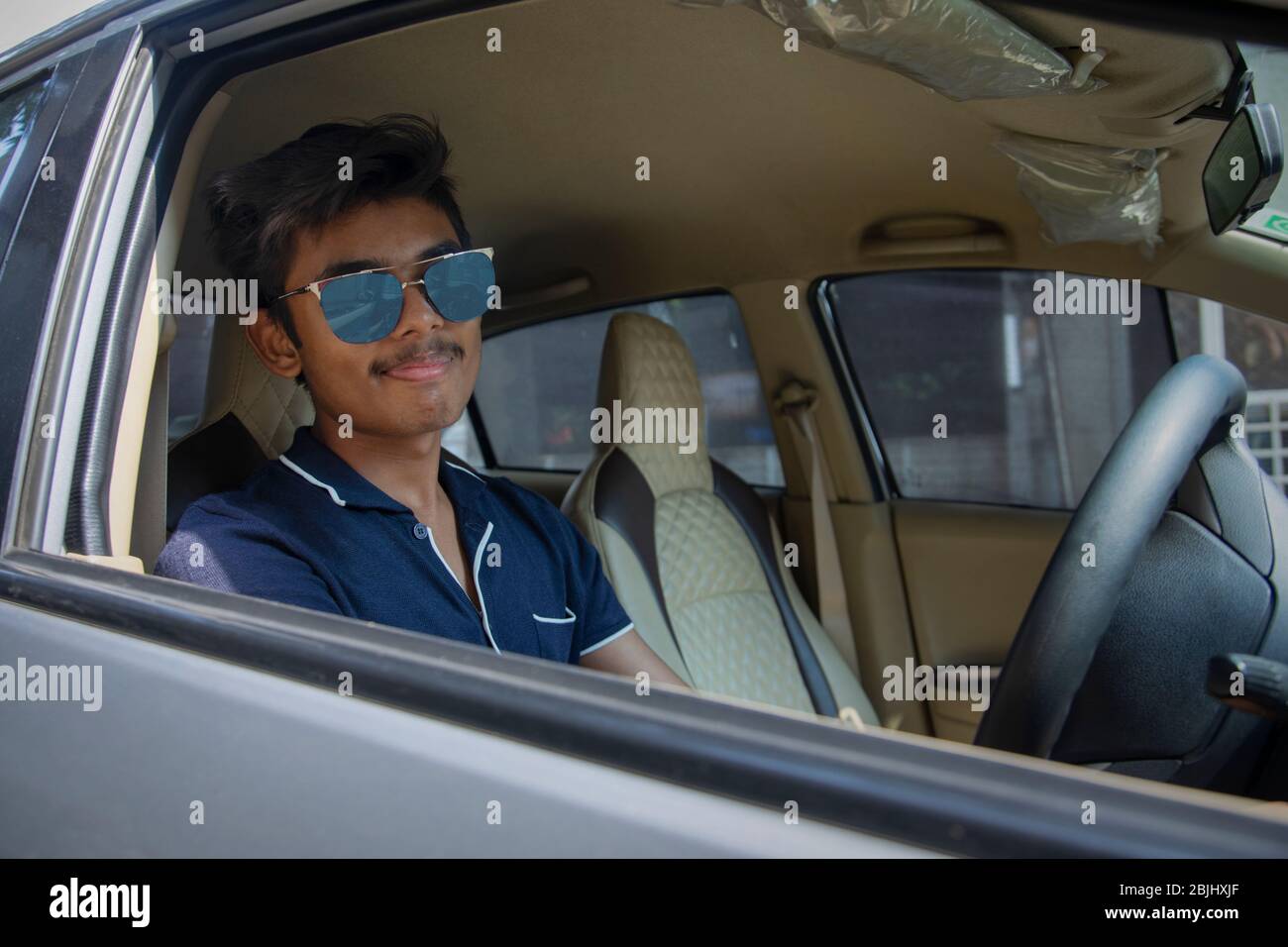 Portrait of young boy sitting inside the car Stock Photo - Alamy