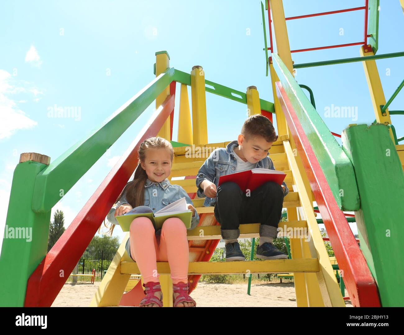 Children reading books on the playground Stock Photo - Alamy