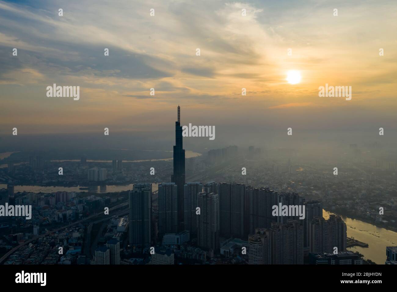 Sunrise drone shot of misty Ho Chi Minh City urban landcape with high ...