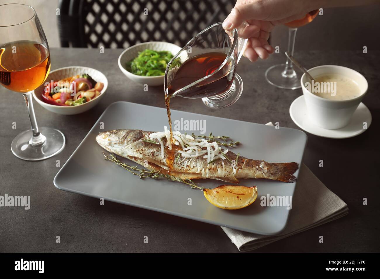 Woman pouring wine sauce hi-res stock photography and images - Alamy
