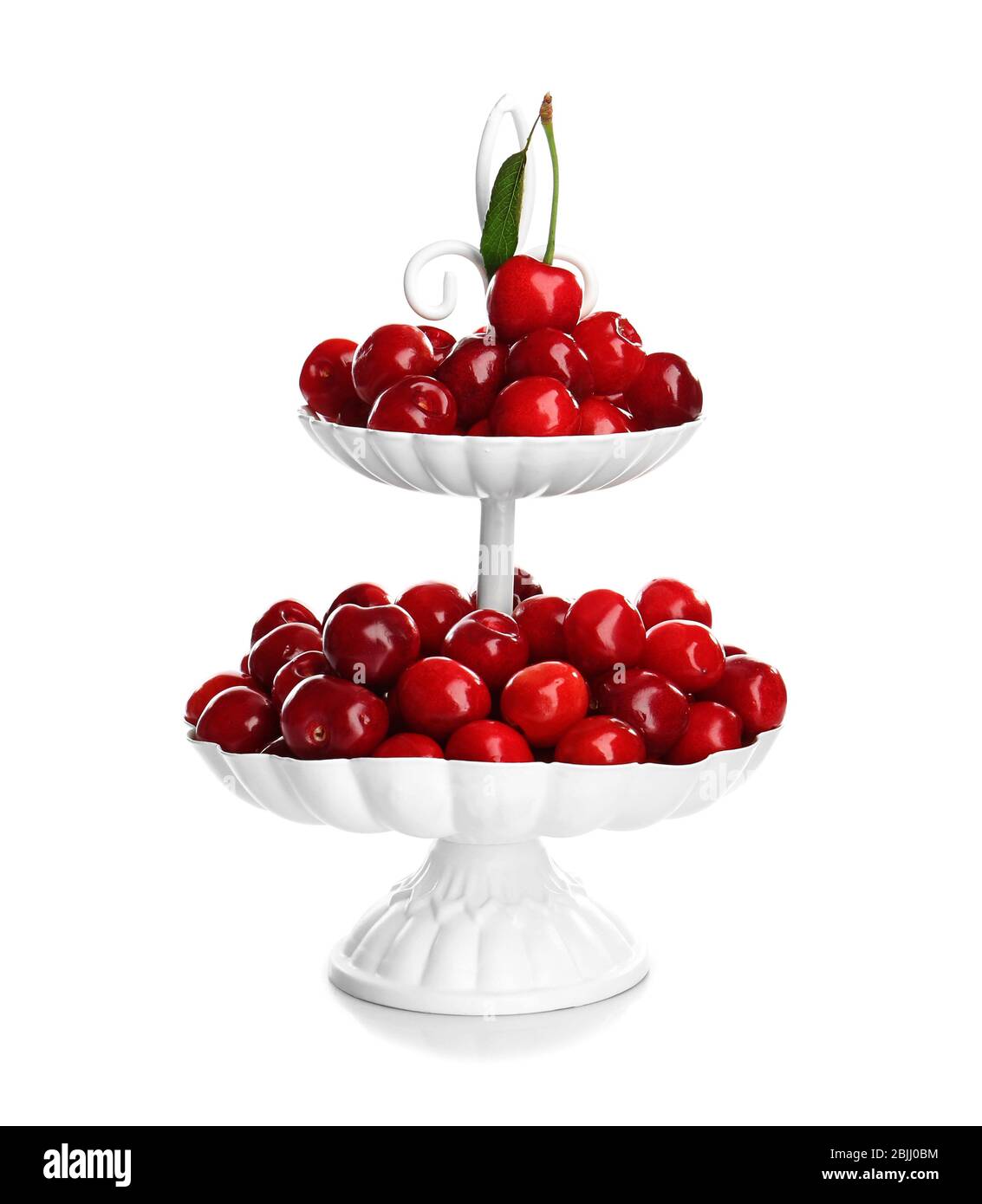 Stand with sweet cherries on white background Stock Photo - Alamy