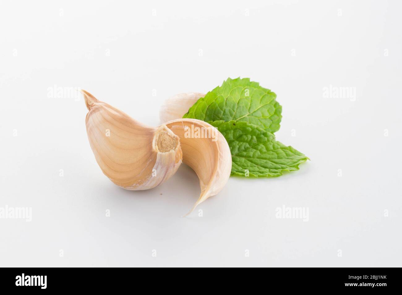garlic with leaves of green mint isolated on white Stock Photo - Alamy