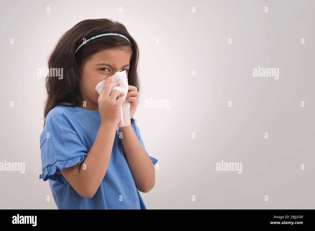 Young girl wiping her nose with a handkerchief. (Children Stock Photo ...