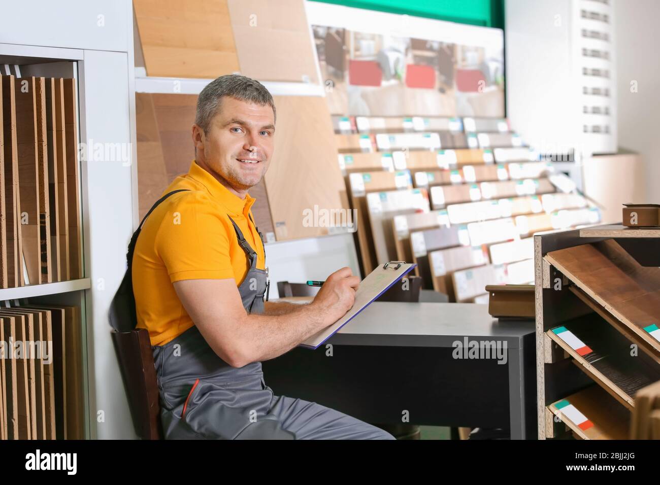 Carpenter making notes in hardware store Stock Photo - Alamy