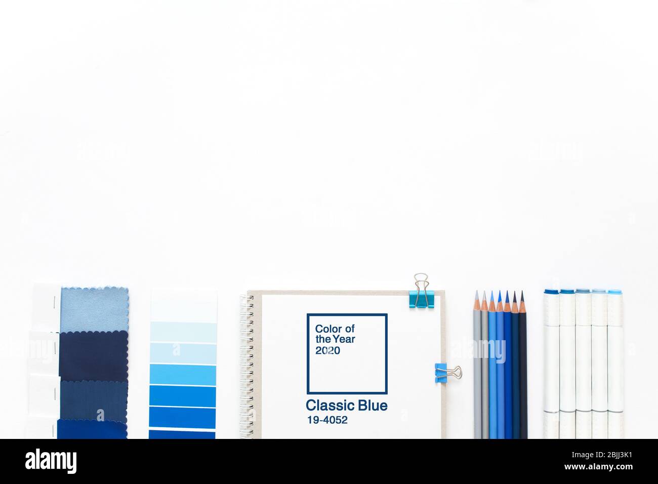 Classic Blue. Color of the Year 2020. Top view of workspace with white ...
