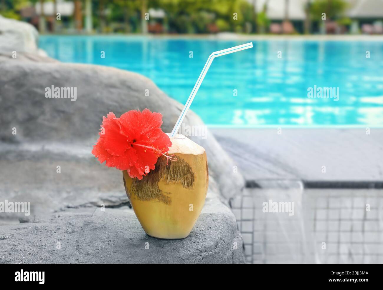 Fresh coconut cocktail near pool at resort Stock Photo - Alamy