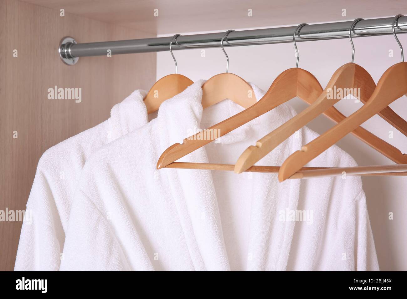 Bathrobes hanging in wardrobe Stock Photo - Alamy