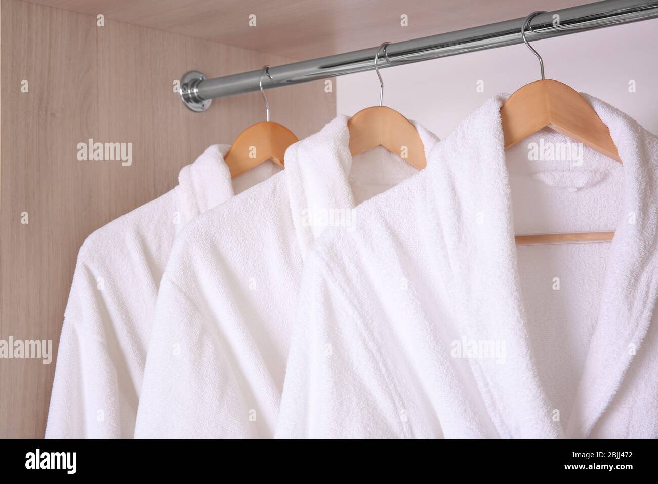 Bathrobes hanging in wardrobe Stock Photo - Alamy