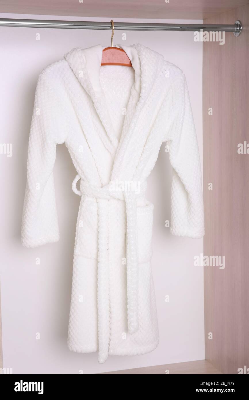 Bathrobe hanging in wardrobe Stock Photo - Alamy