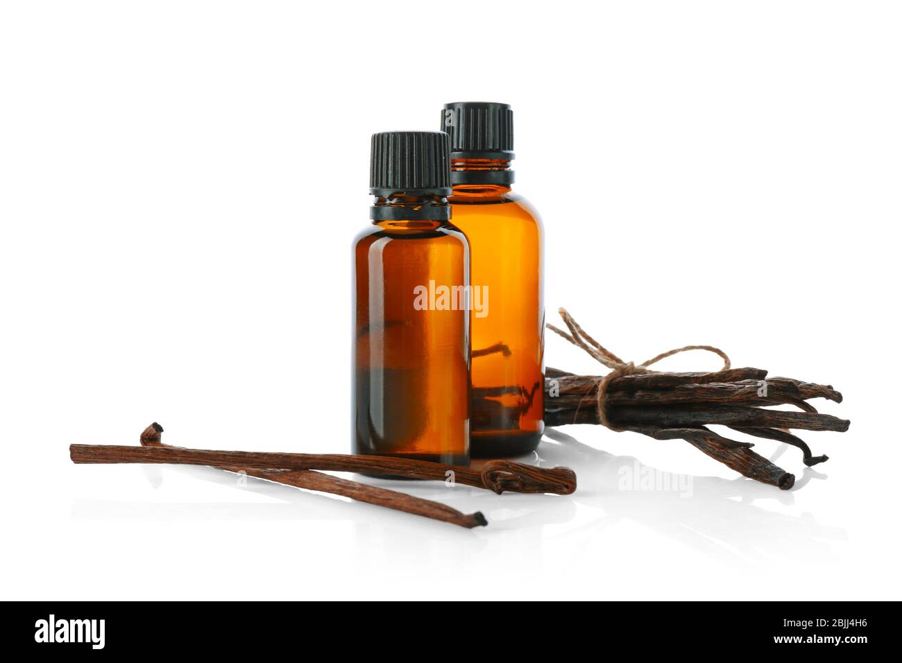 Bottles with vanilla extract and sticks on white background Stock Photo ...
