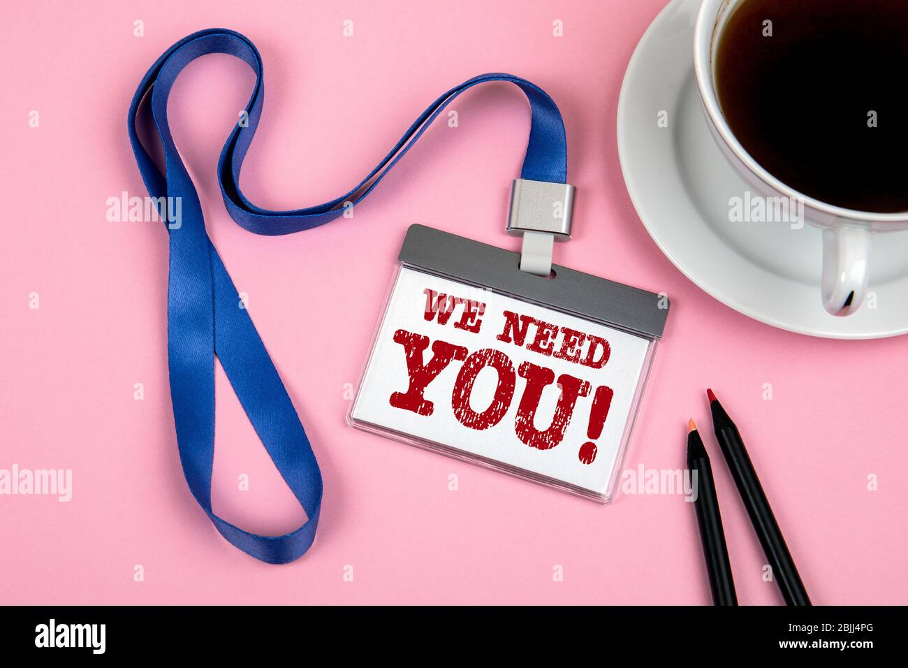 WE NEED YOU. Staff Identity, colored pencils and a cup of coffee on a ...