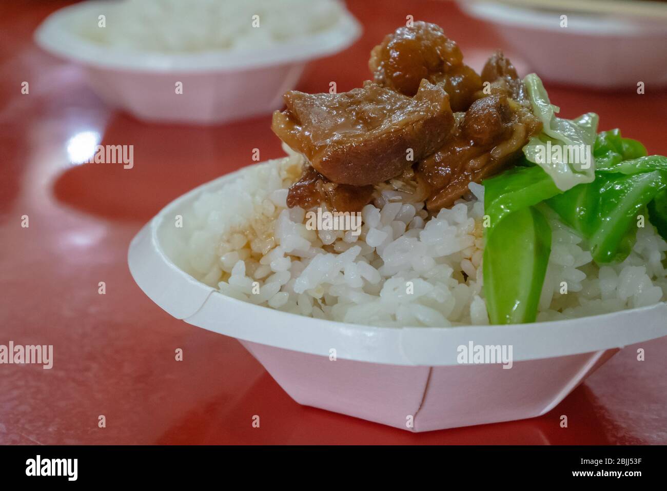 The close up of Taiwanese pork knuckle rice food on paper cup at taiwan ...
