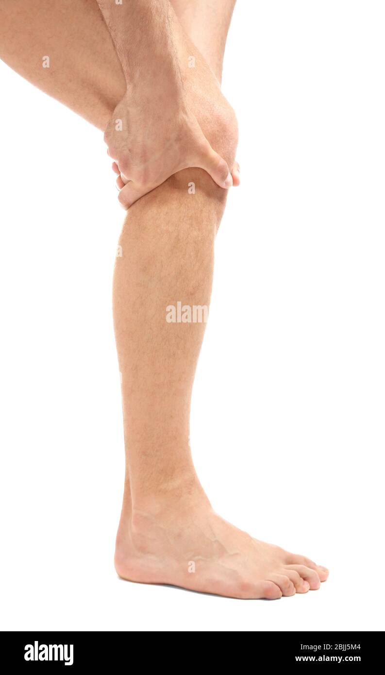 Young man suffering from pain in leg on white background Stock Photo ...