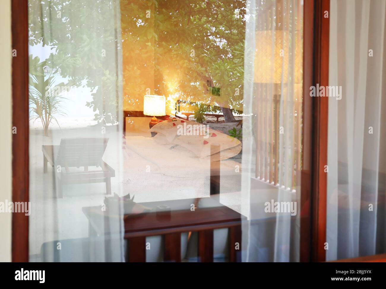 View of modern hotel room at tropical resort through window Stock Photo ...