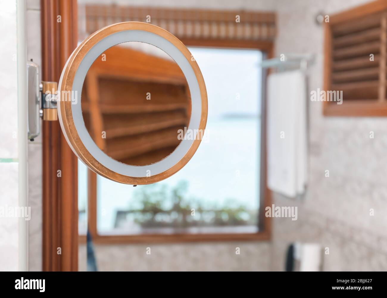 Small round mirror in hotel bathroom Stock Photo - Alamy