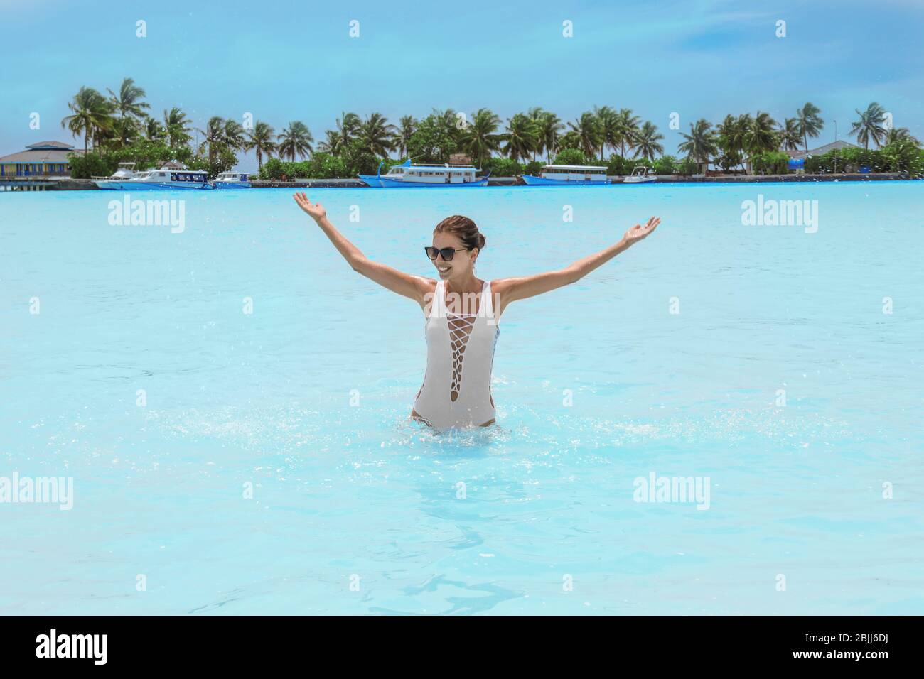 Beautiful young woman bathing at sea resort Stock Photo - Alamy