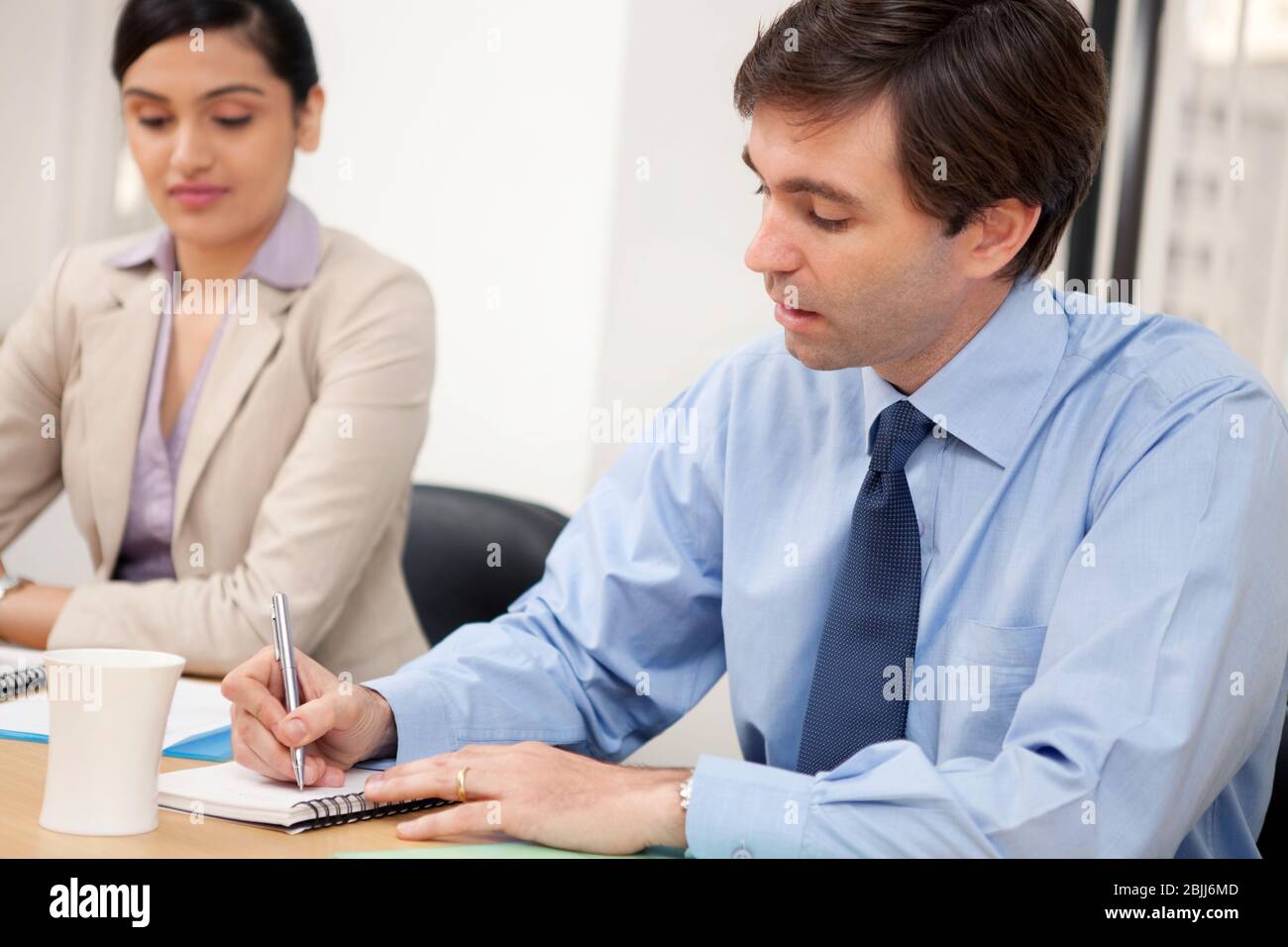 Business executive taking notes Stock Photo - Alamy