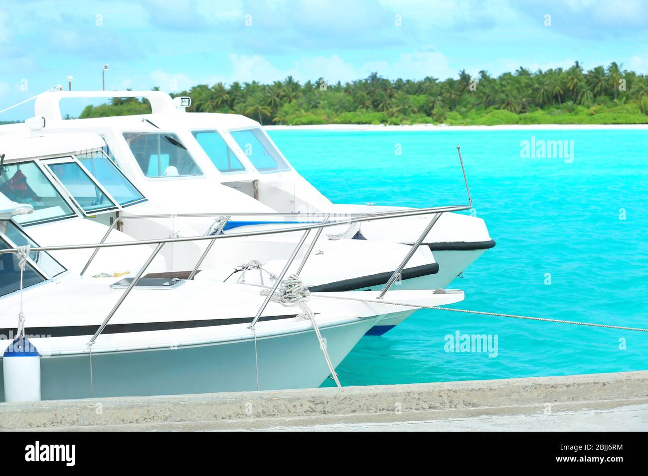 Modern boats berthed at resort Stock Photo - Alamy