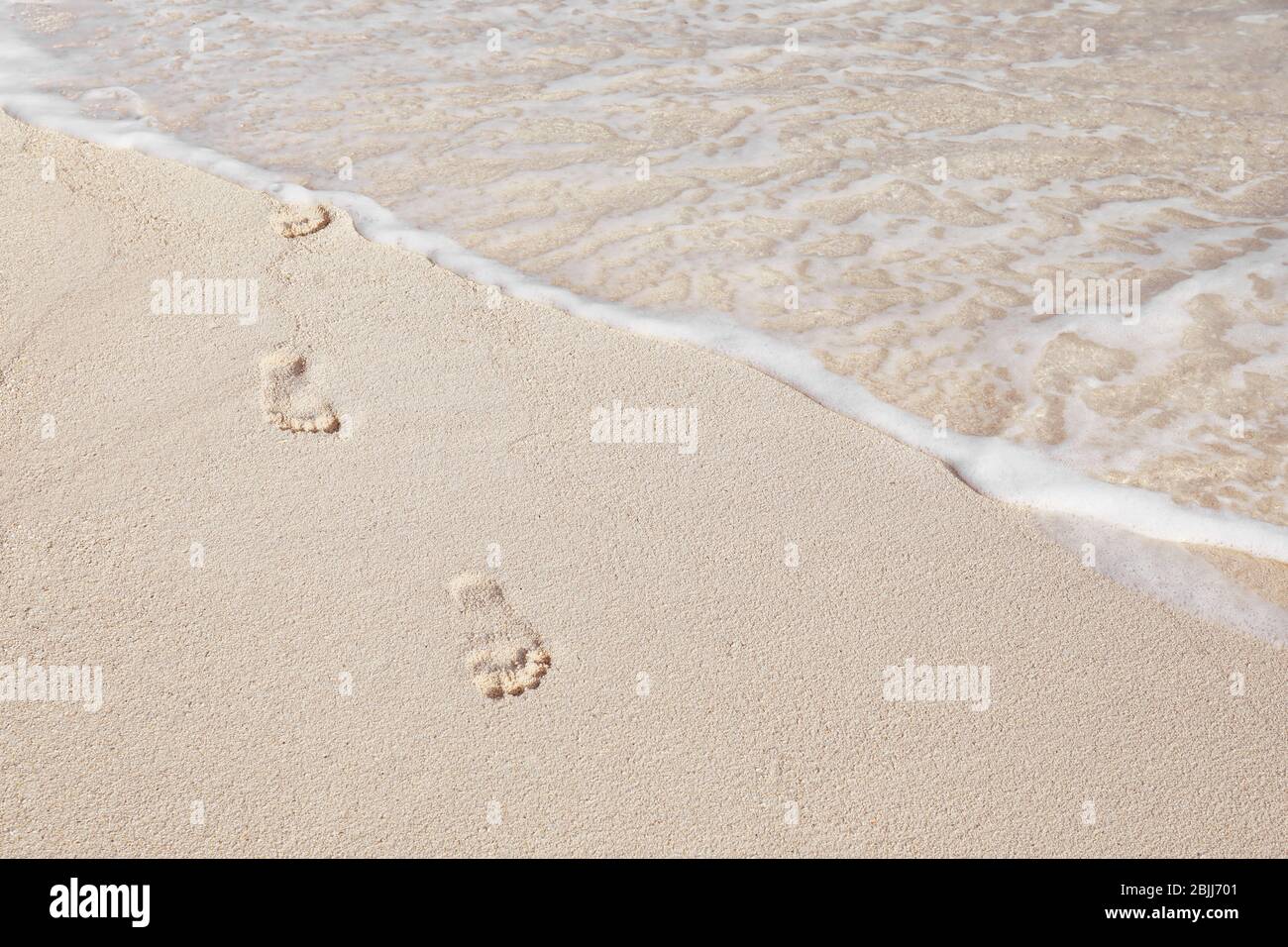 Human footprints on beach sand at resort Stock Photo - Alamy