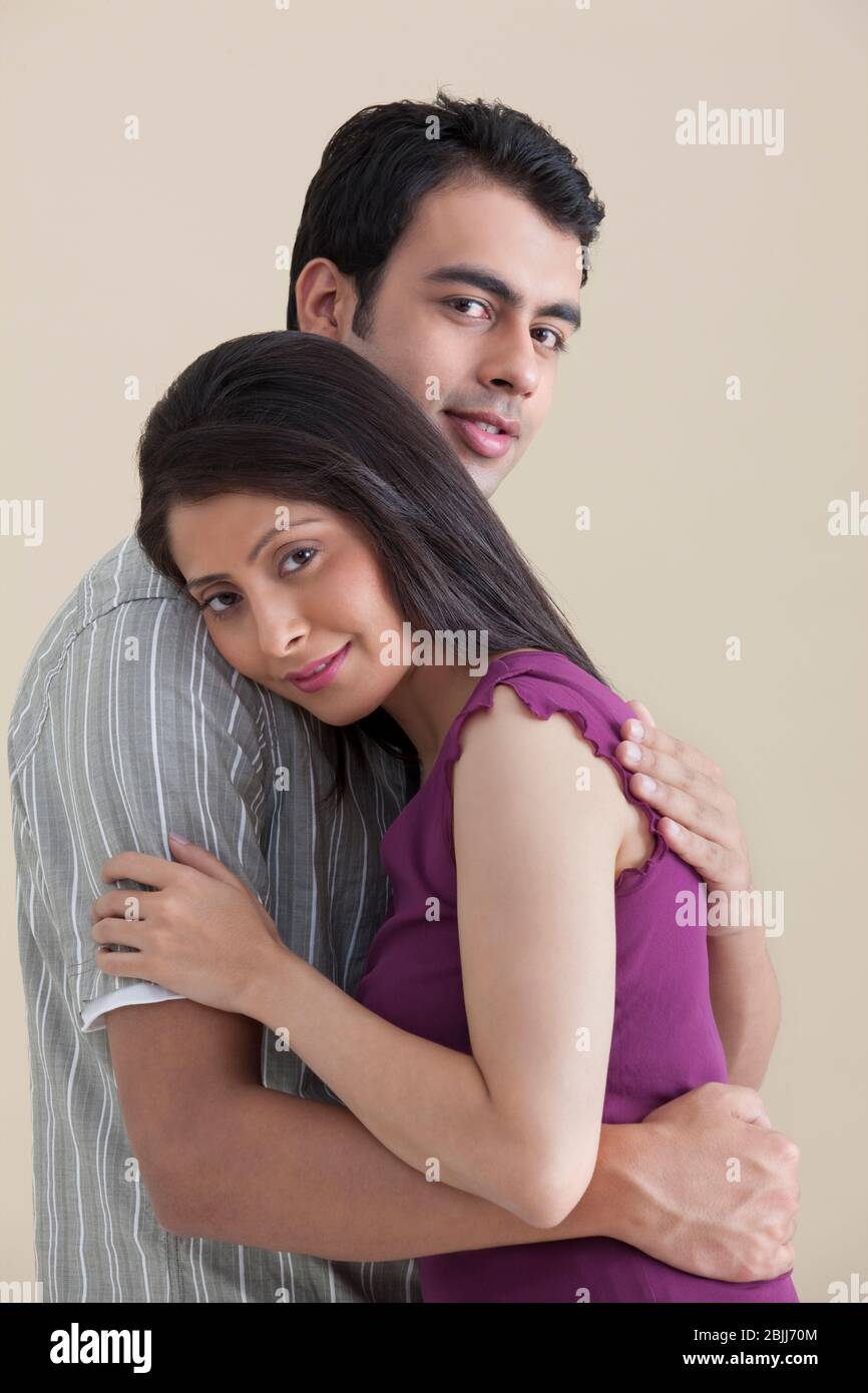 Portrait of married couple hugging Stock Photo - Alamy