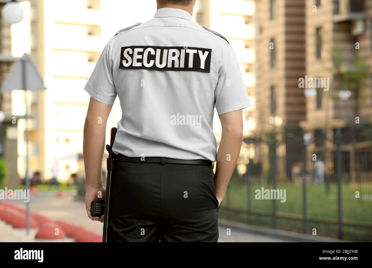 Male security guard standing outdoors Stock Photo - Alamy