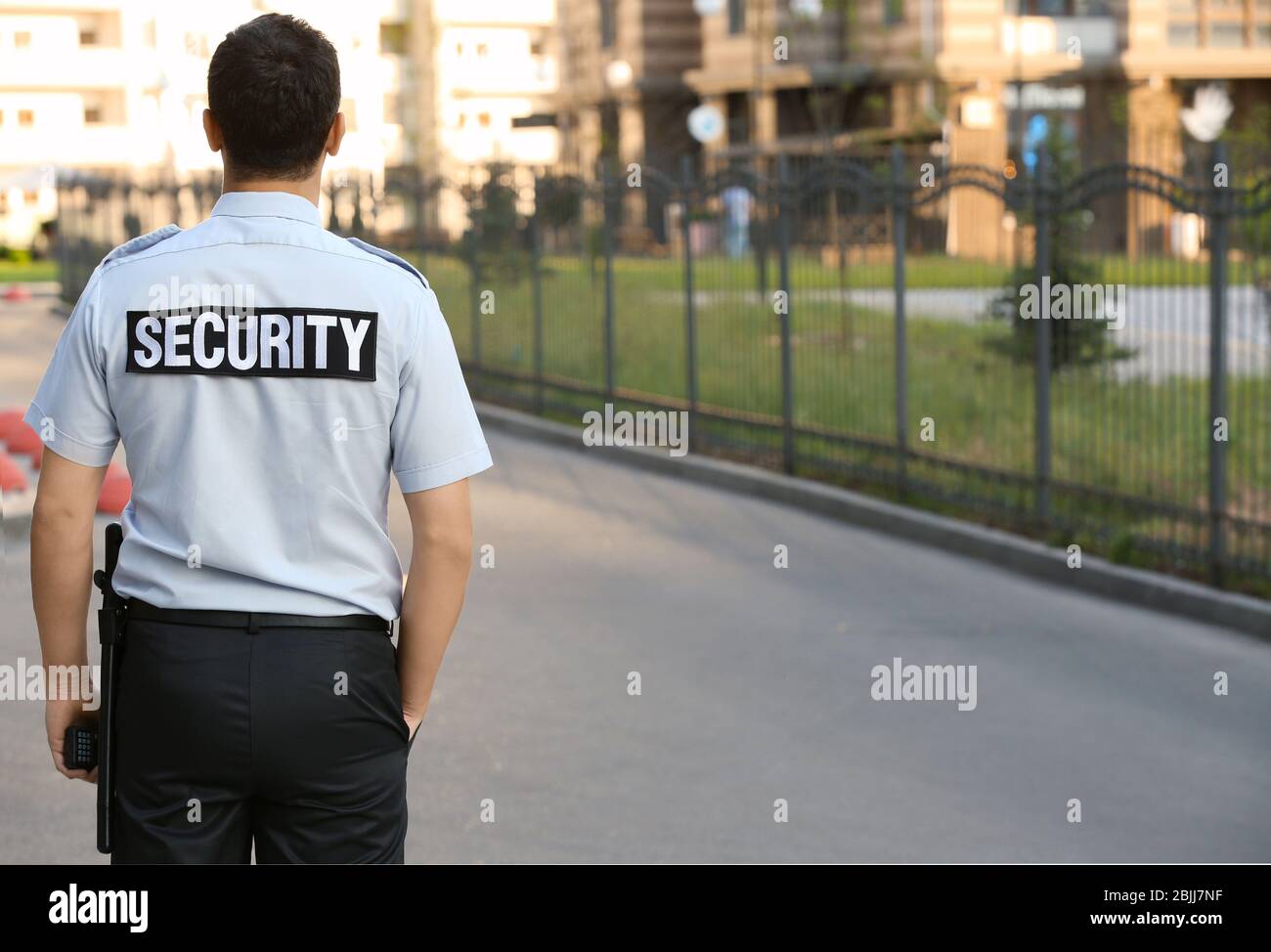 Male security guard standing outdoors Stock Photo - Alamy