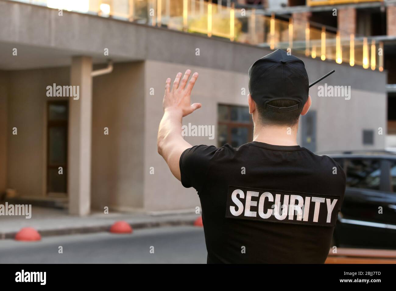 Male security guard with portable radio, outdoors Stock Photo - Alamy