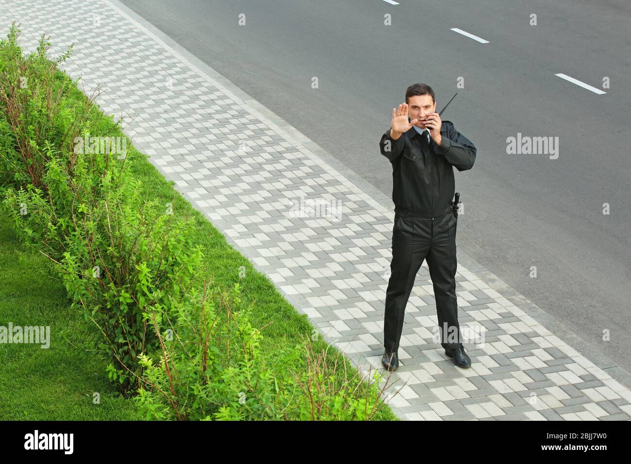 Male security guard with portable radio, outdoors Stock Photo - Alamy