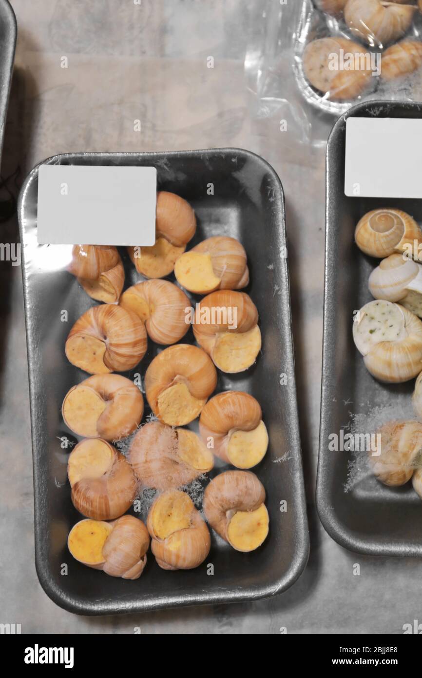 Snails in packing on counter Stock Photo - Alamy