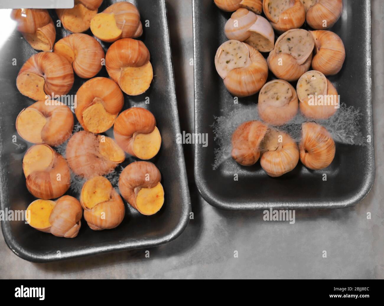 Snails in packing on counter Stock Photo - Alamy