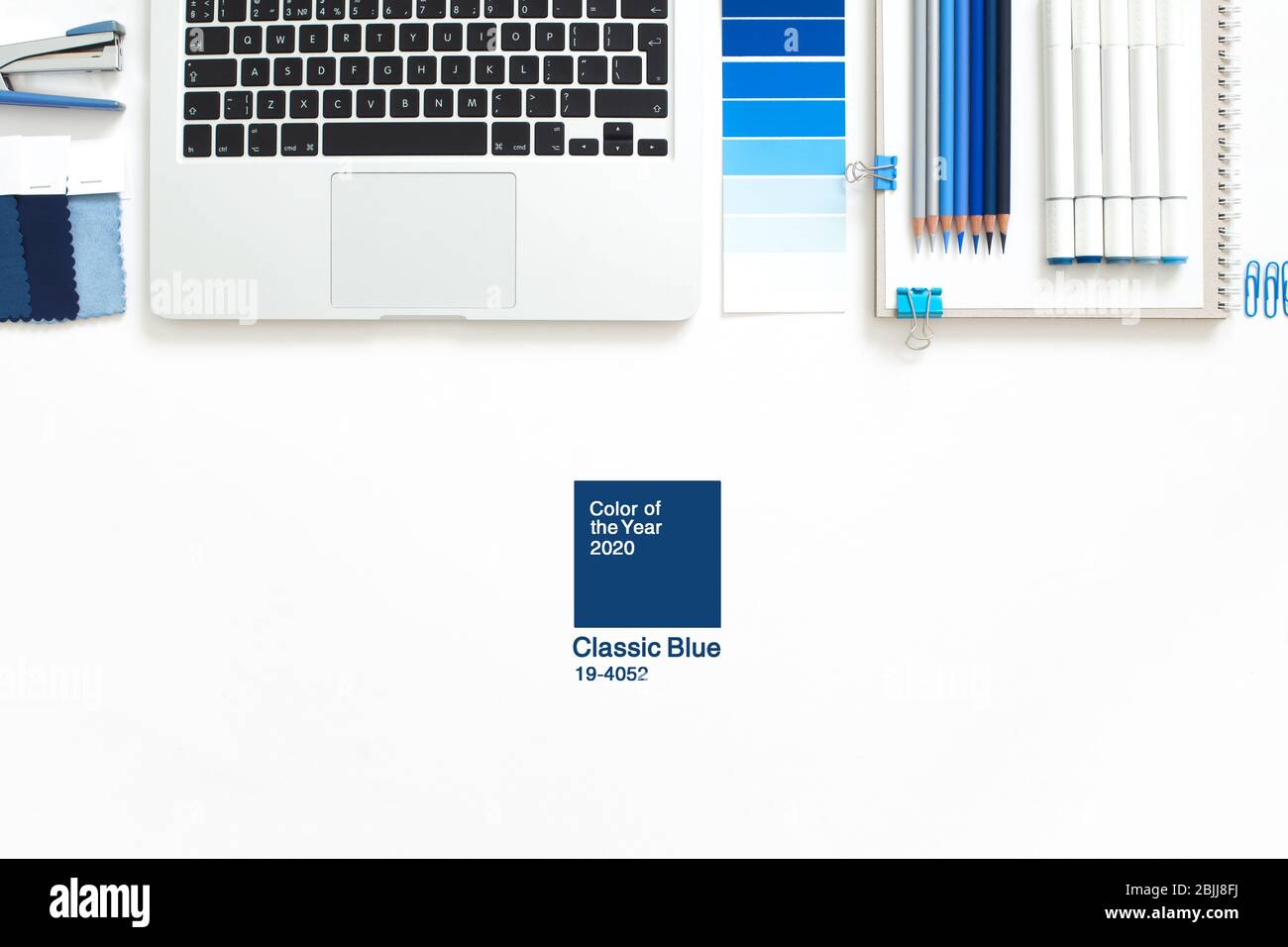 Classic Blue. Color of the Year 2020. Top view of workspace with white ...