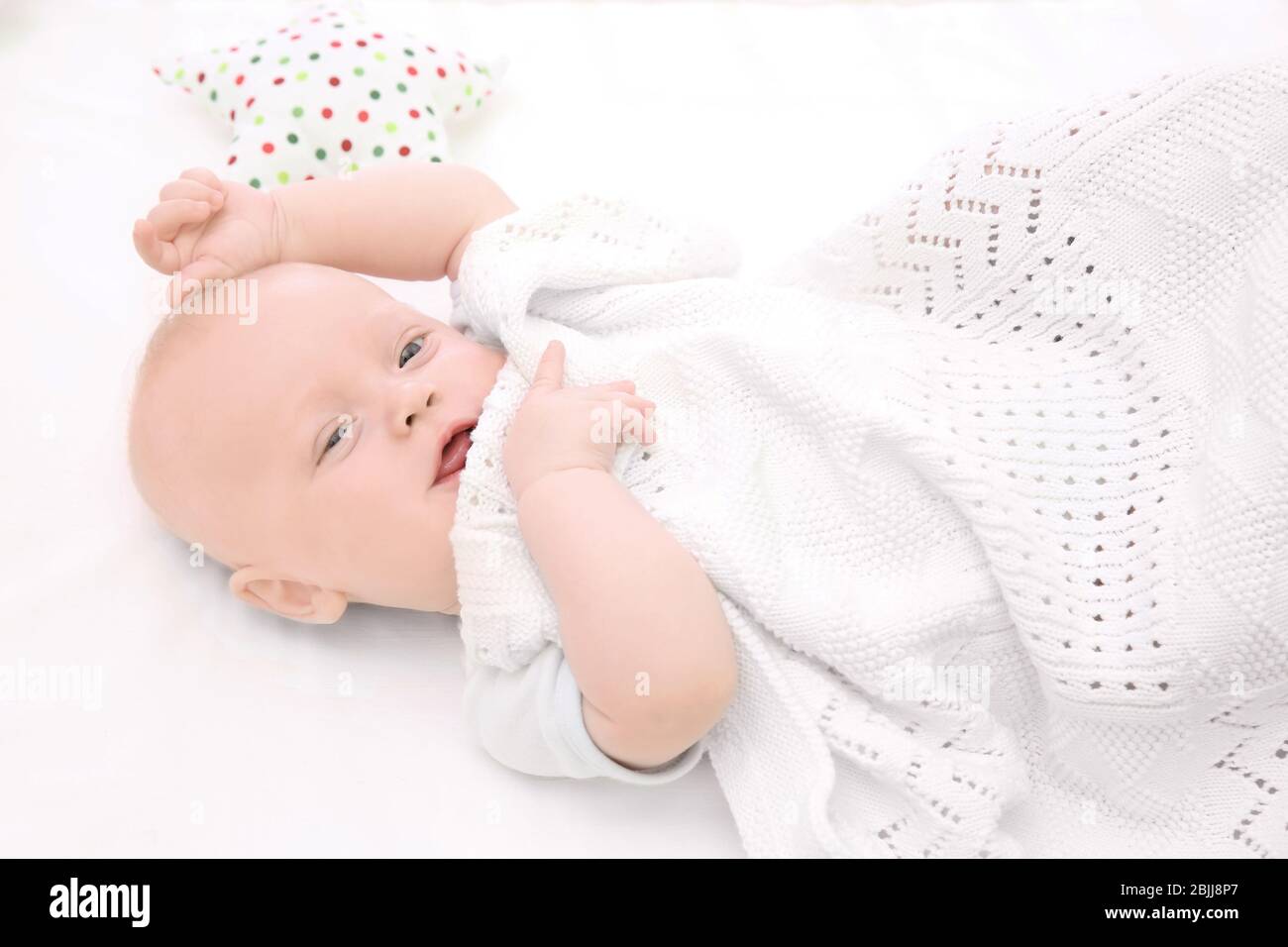 Emotional baby lying in cradle. Insomnia and sleep disorders concept ...