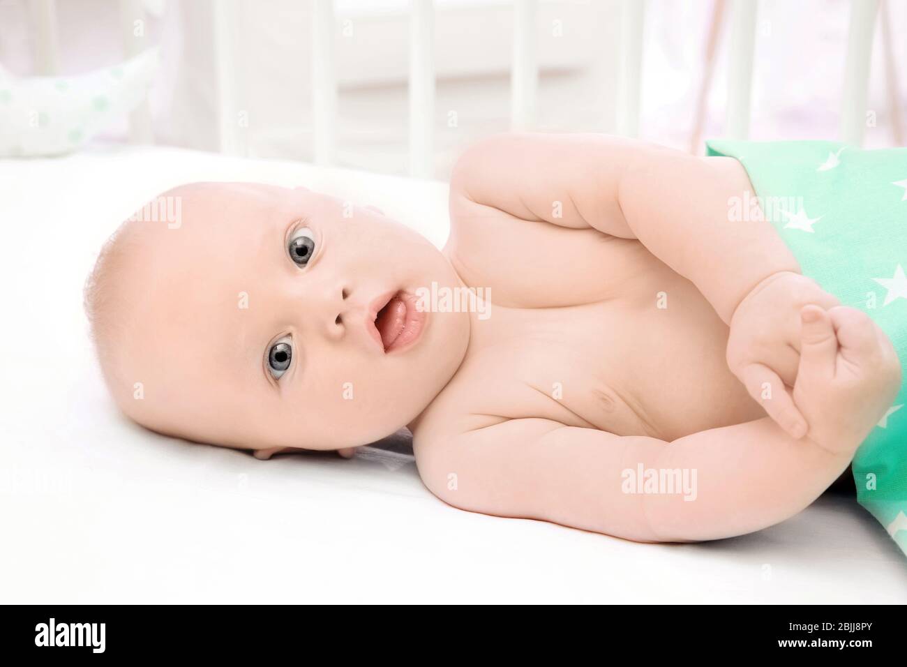 Emotional baby lying in cradle. Insomnia and sleep disorders concept ...