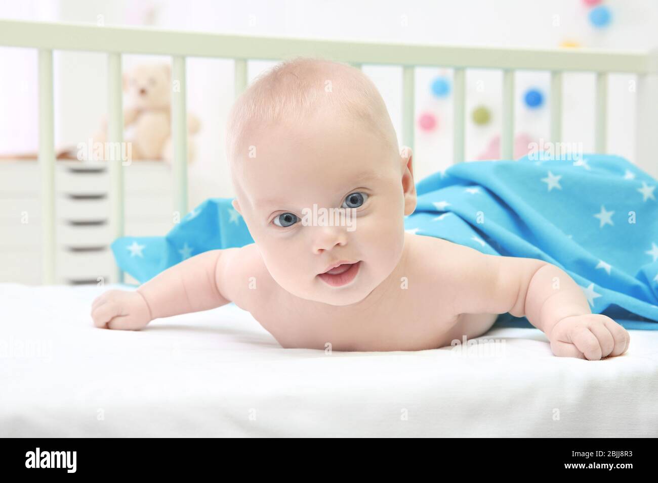 Emotional baby lying in cradle. Insomnia and sleep disorders concept ...