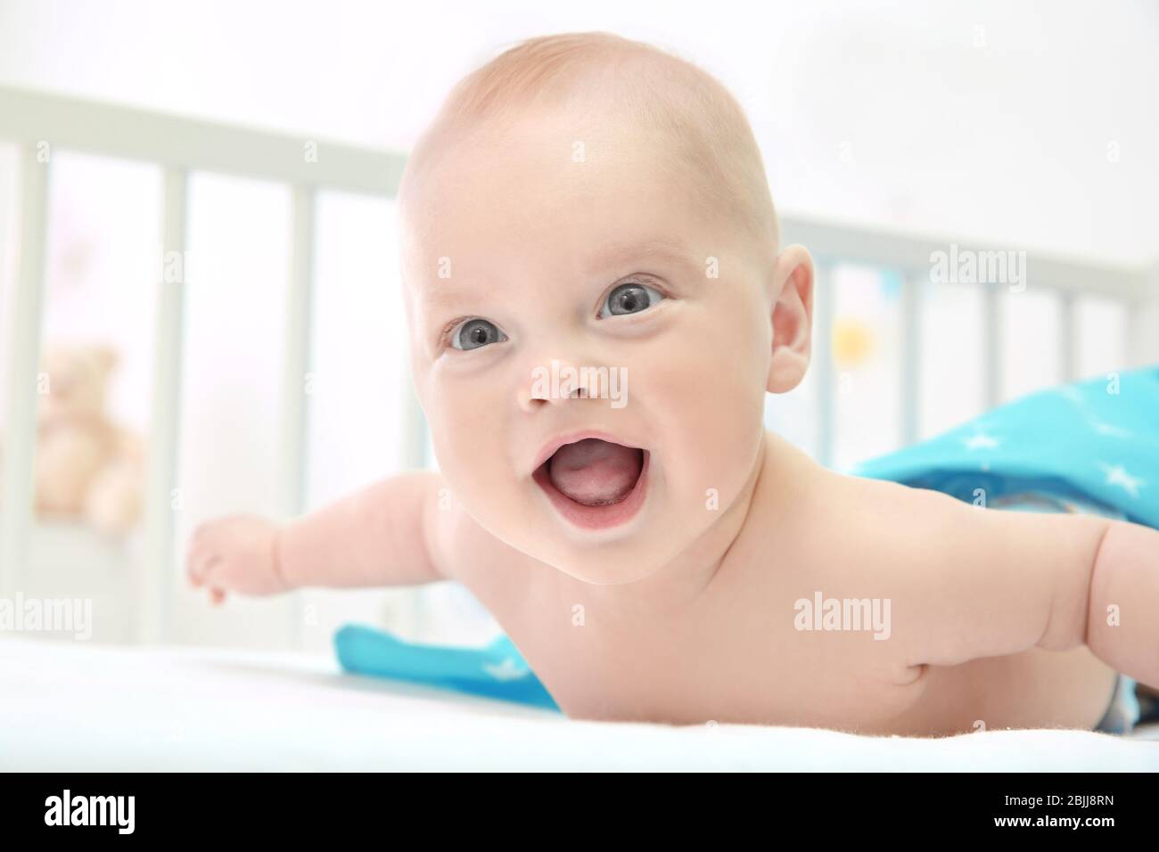 Emotional baby lying in cradle. Insomnia and sleep disorders concept ...