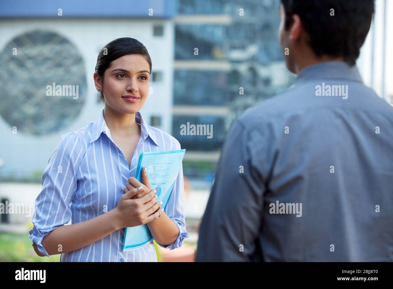 Female executive holding a file Stock Photo - Alamy
