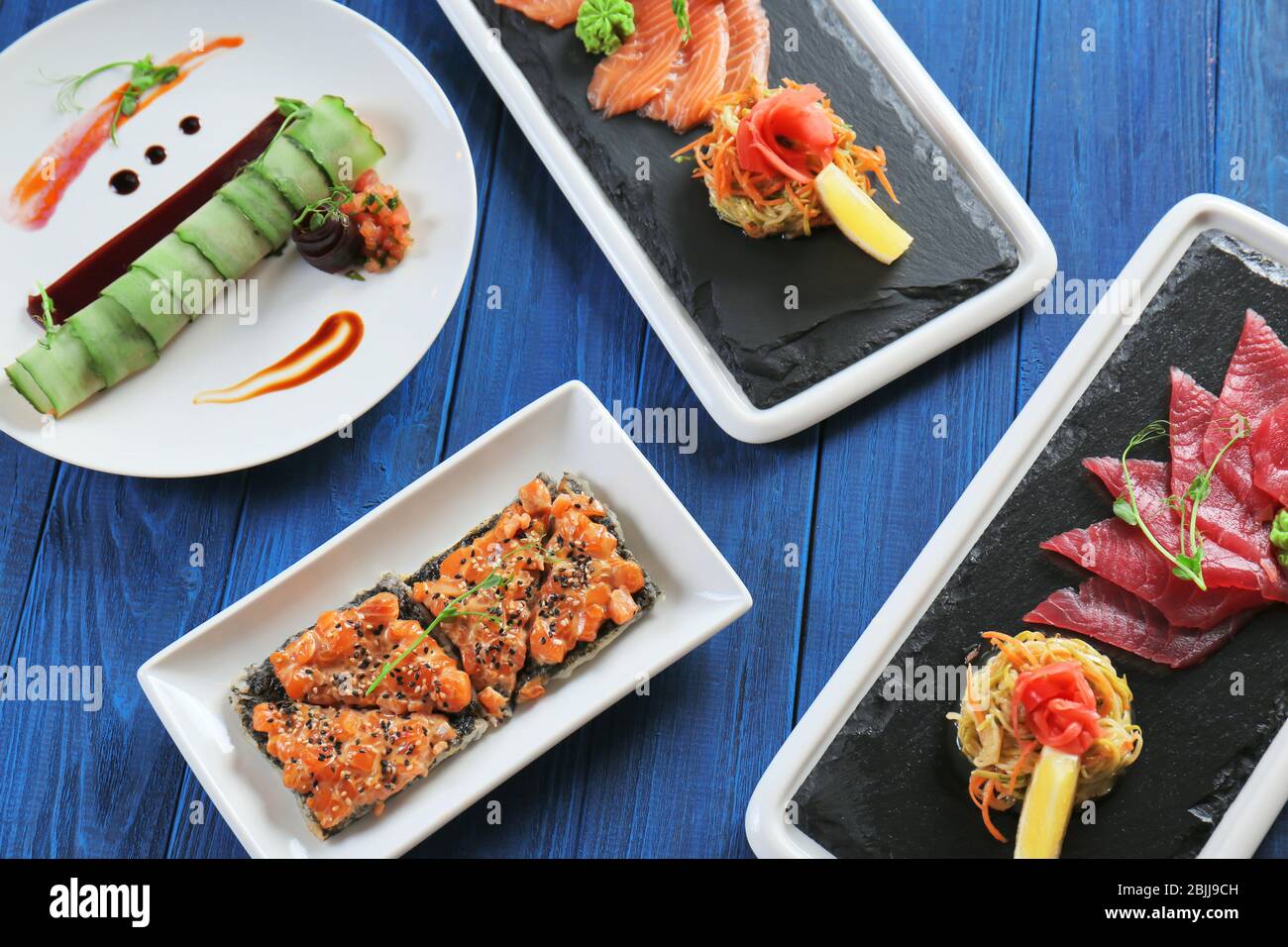 Different dishes with seafood on wooden background Stock Photo - Alamy