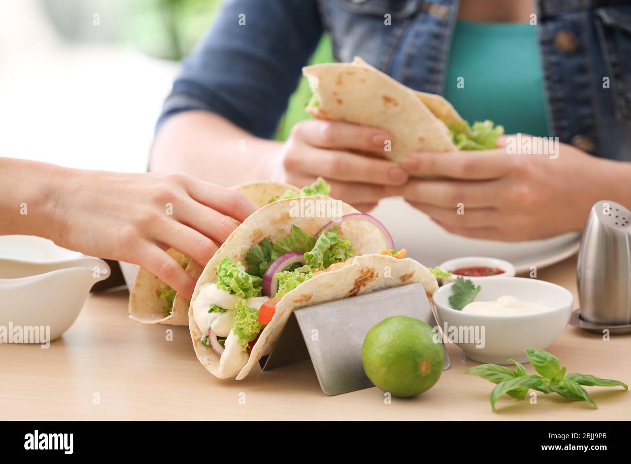Female eating tacos hi-res stock photography and images - Alamy