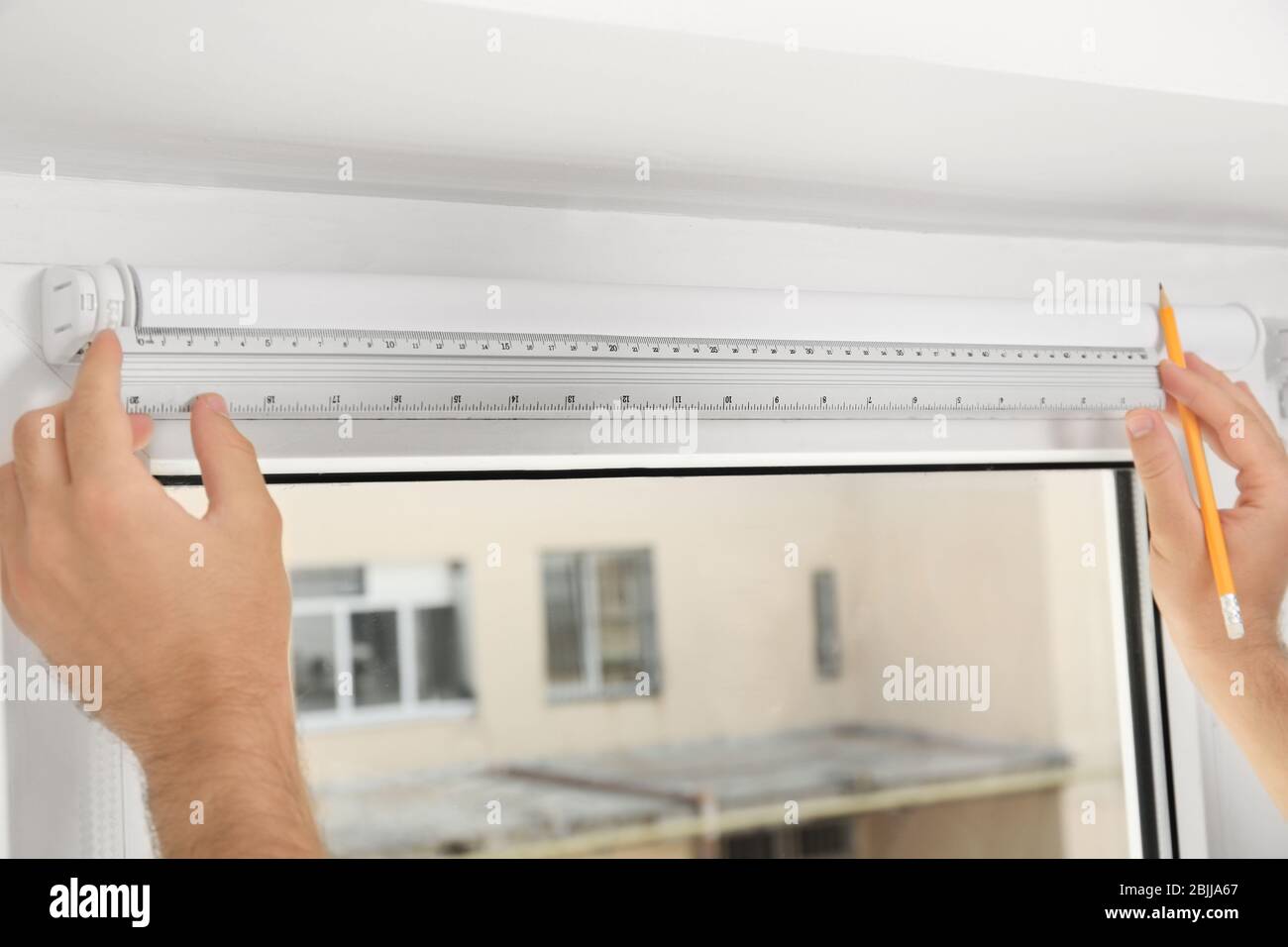 Young man installing window hi-res stock photography and images - Alamy